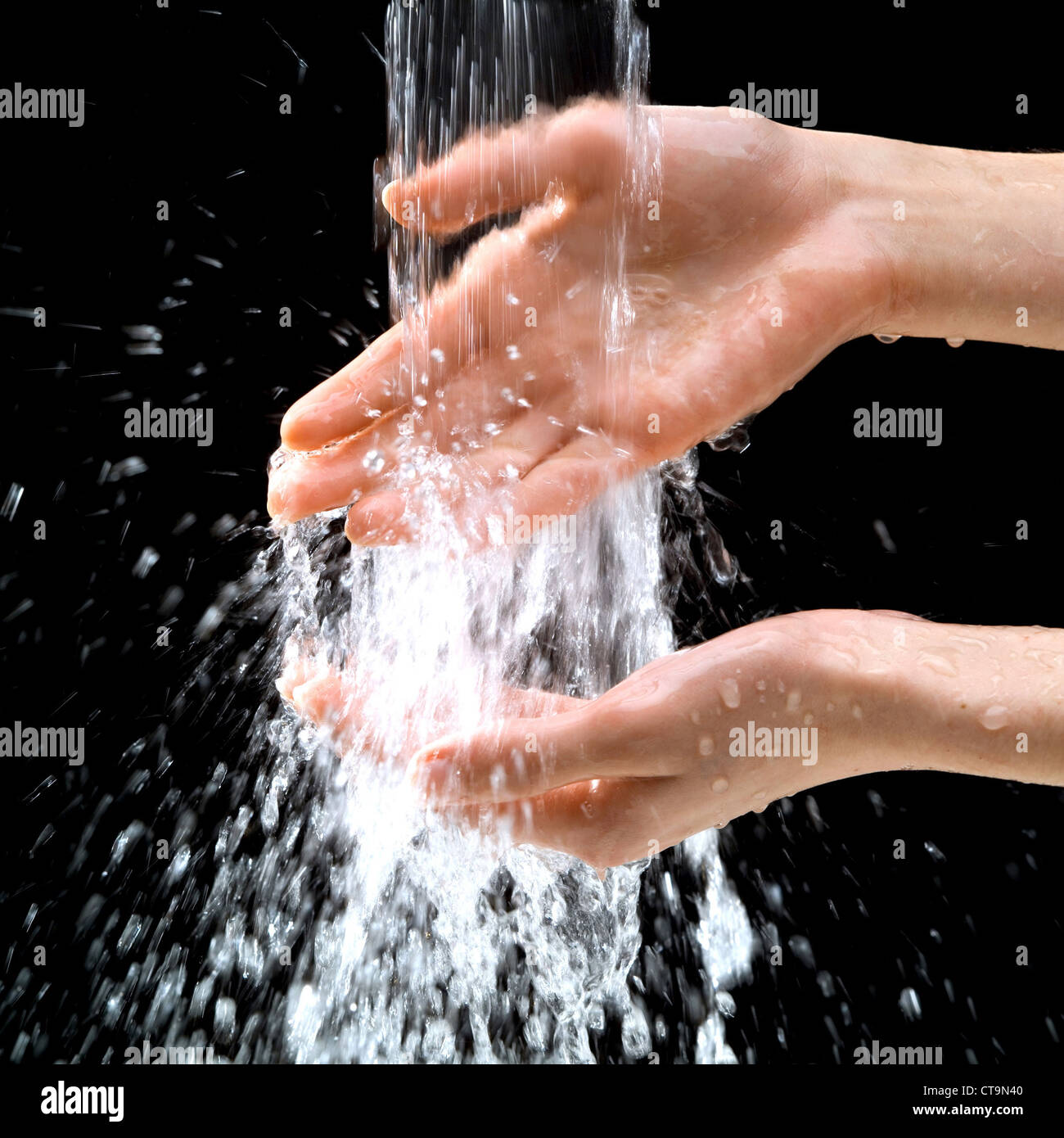 Hands under a stream of water Stock Photo - Alamy