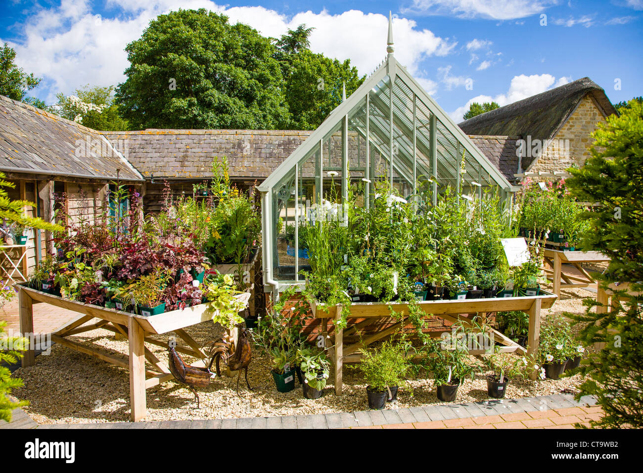 Painted greenhouse and plant stalls in the attractive garden centre at ...