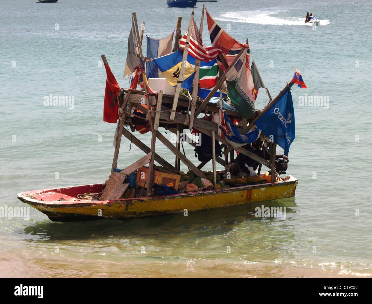 A fruit boat with many international flags at the beach in Rodney Bay ...