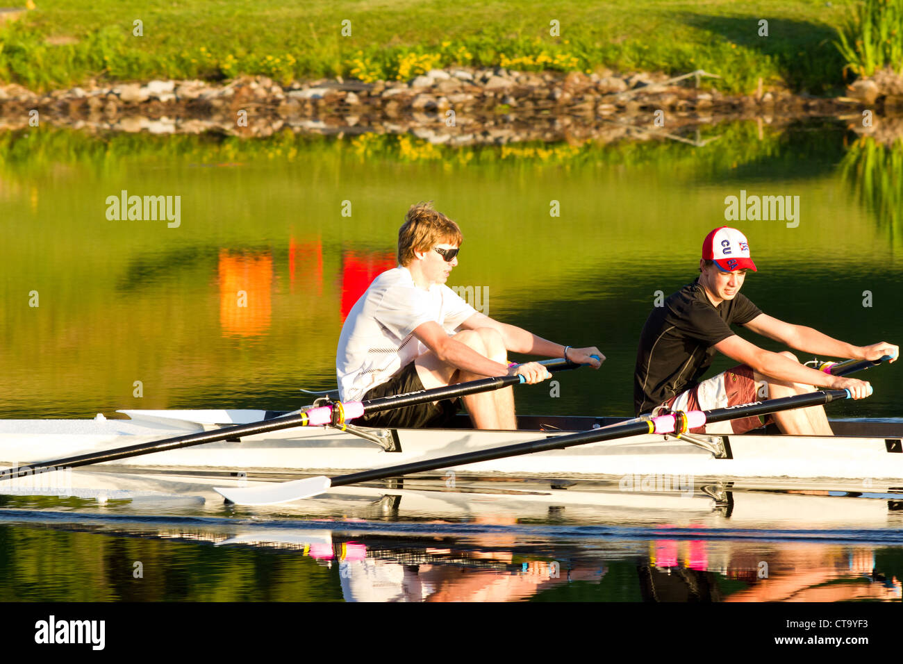 Two young men rowing Stock Photo - Alamy
