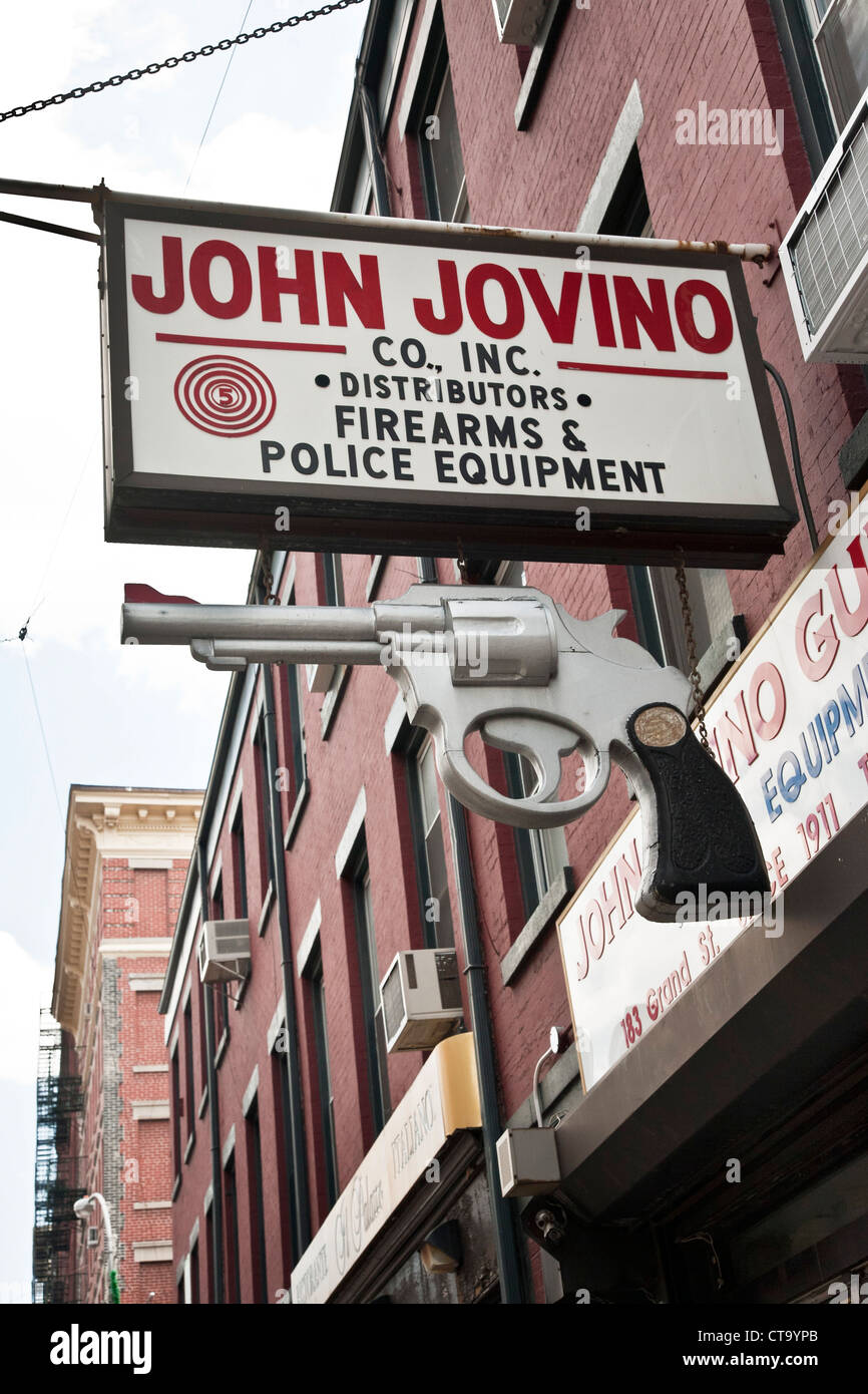 gun shop sign with realistic oversize carved revolver hanging under it ...