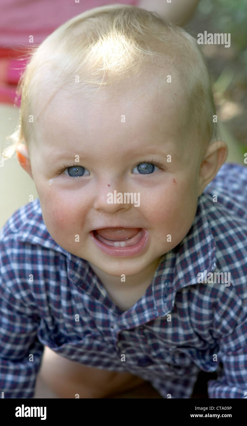 Baby with two teeth in the summer in the garden Stock Photo - Alamy