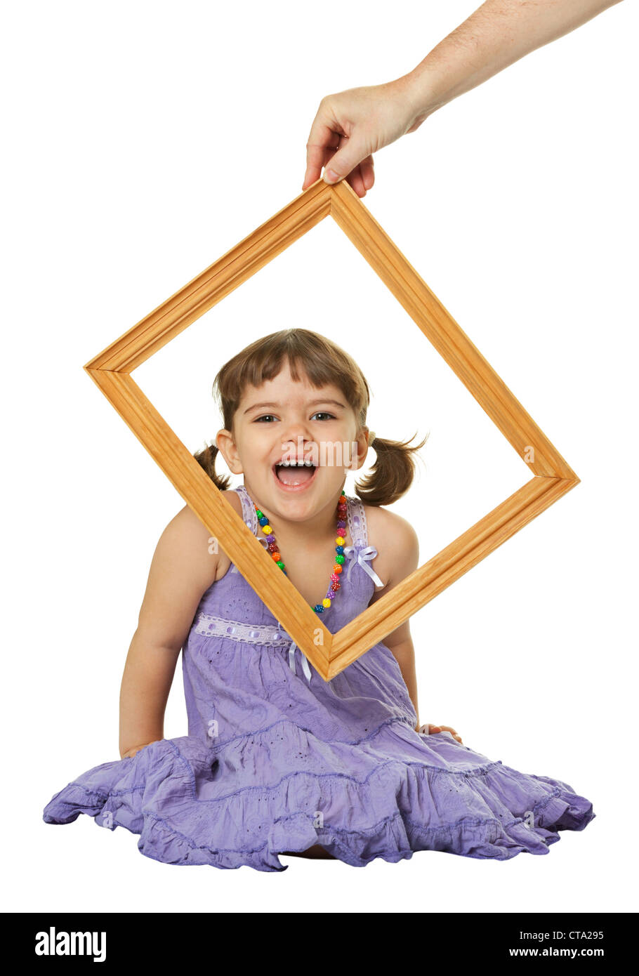 Happy little girl looking through the frame isolated on white ...