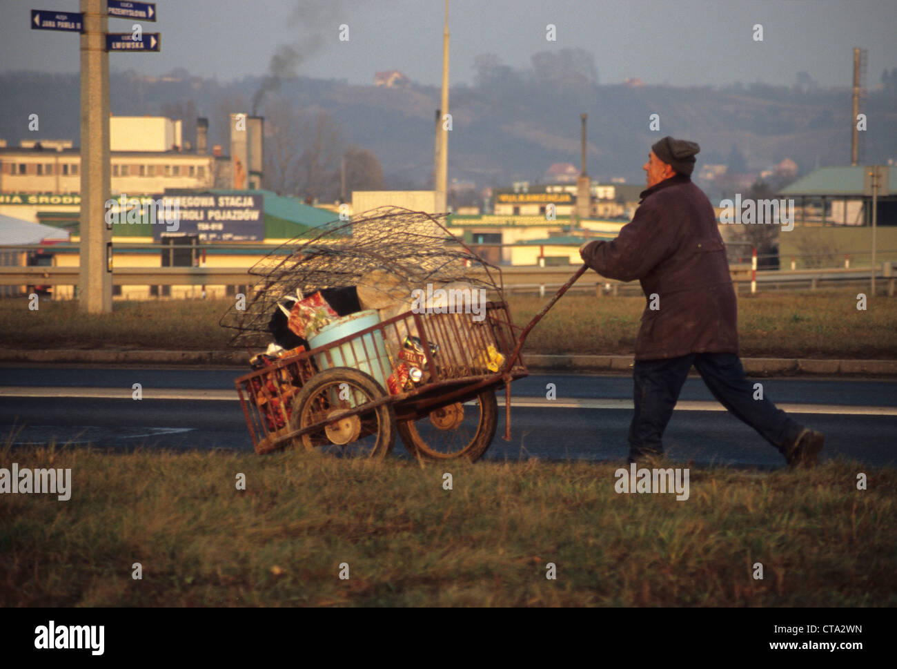 Man pushing a trolley full of junk, Sandomierz, Poland Stock Photo - Alamy