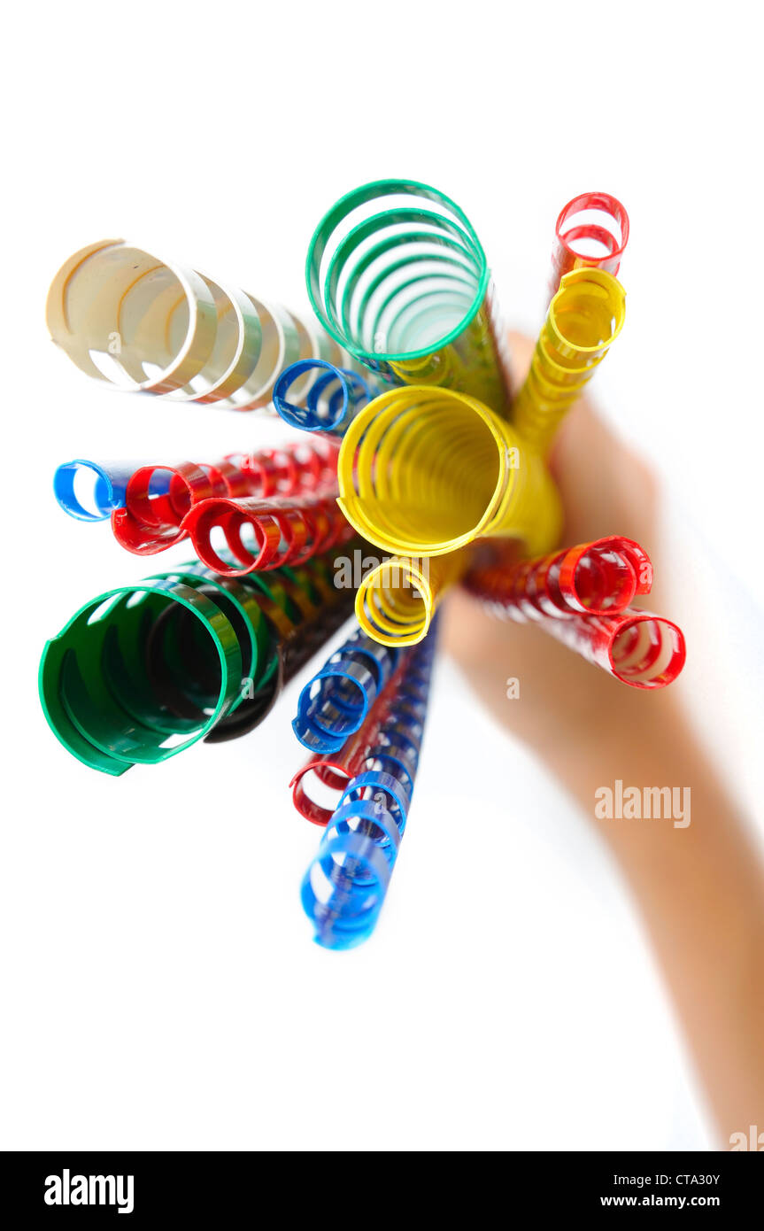 colorful plastic multi-ring paper binding spine in hand Stock Photo - Alamy