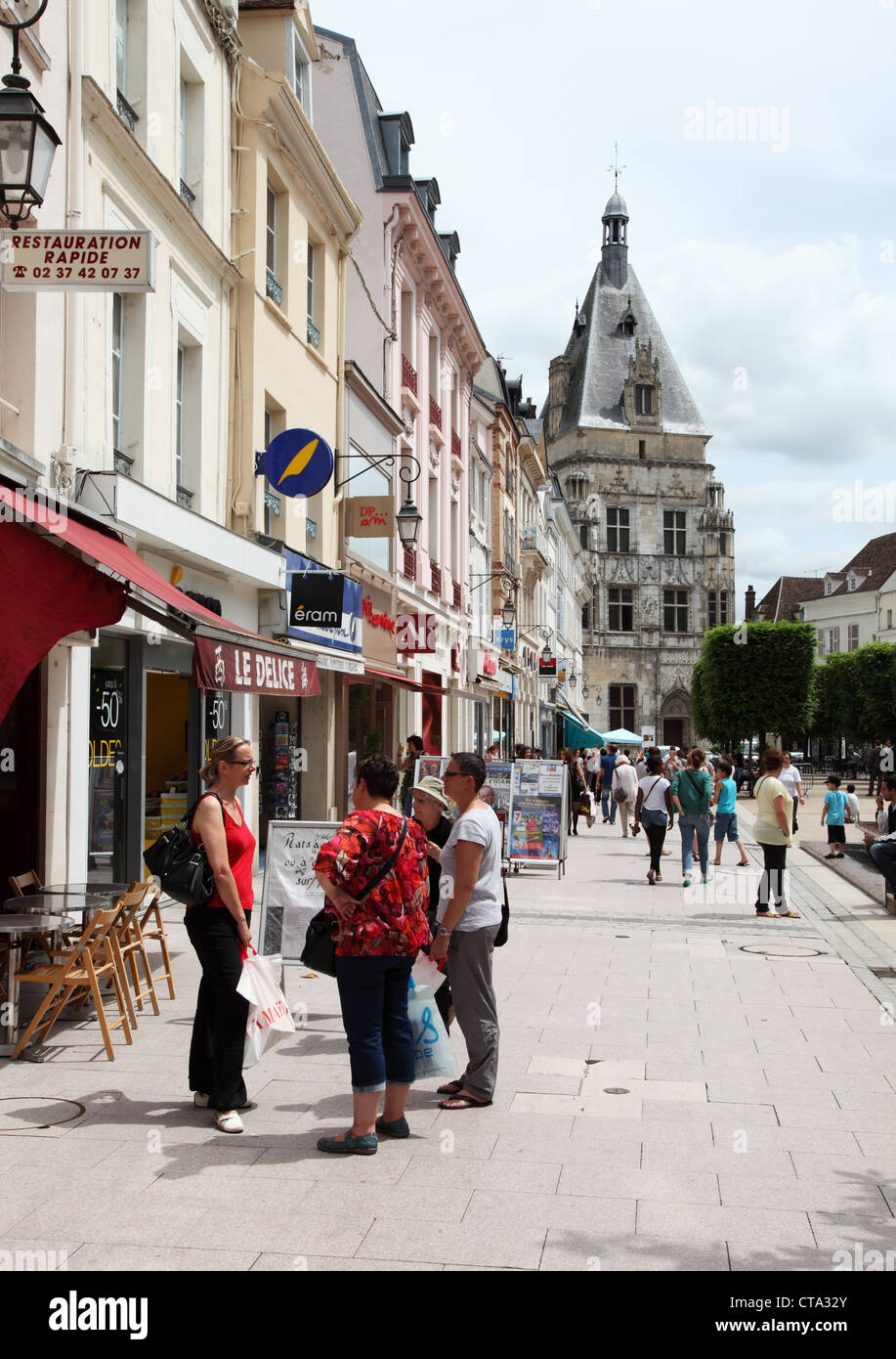 People standing and walking along the Grande Rue within the French town ...