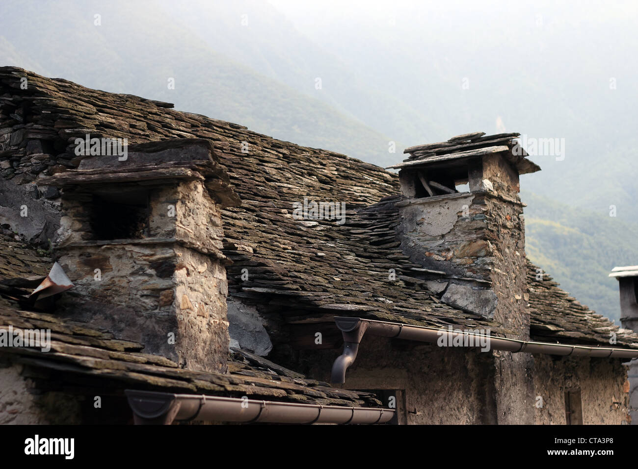 traditional chimneys and roofs in Vogogna Village, Italian Alps Stock ...