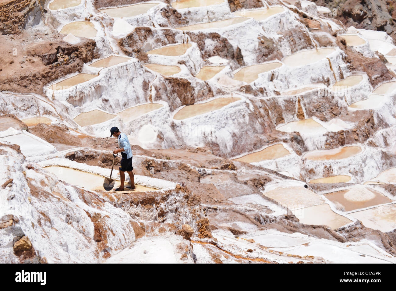 A man working at salt pans near Maras, Peru Stock Photo - Alamy