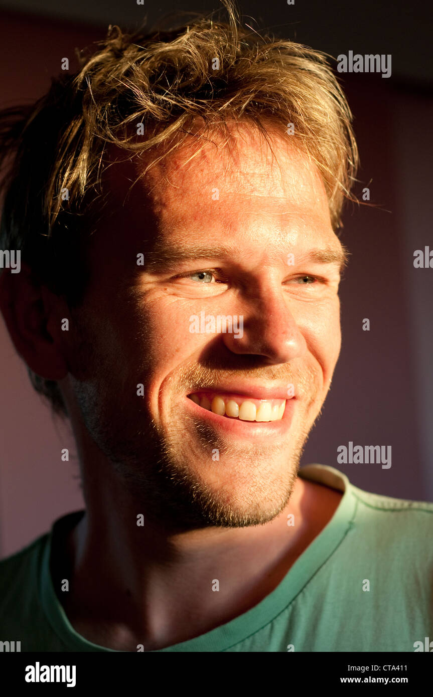 Young man in sunlight, smiling Stock Photo - Alamy