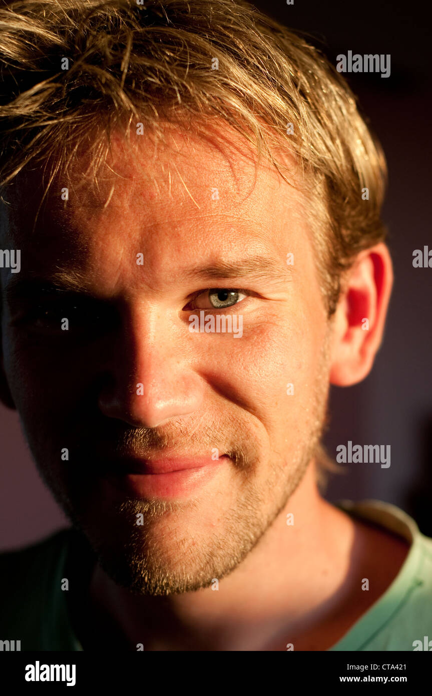Young man in sunlight, smiling Stock Photo - Alamy