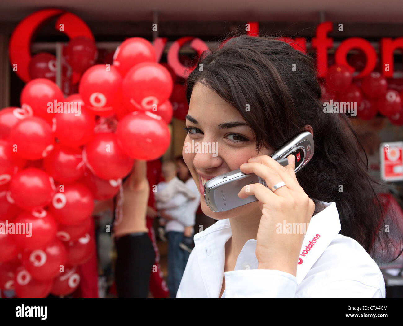 Berlin, Vodafone employee with a mobile phone Stock Photo - Alamy