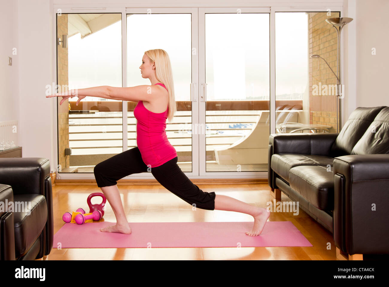 woman doing yoga stretches Stock Photo - Alamy