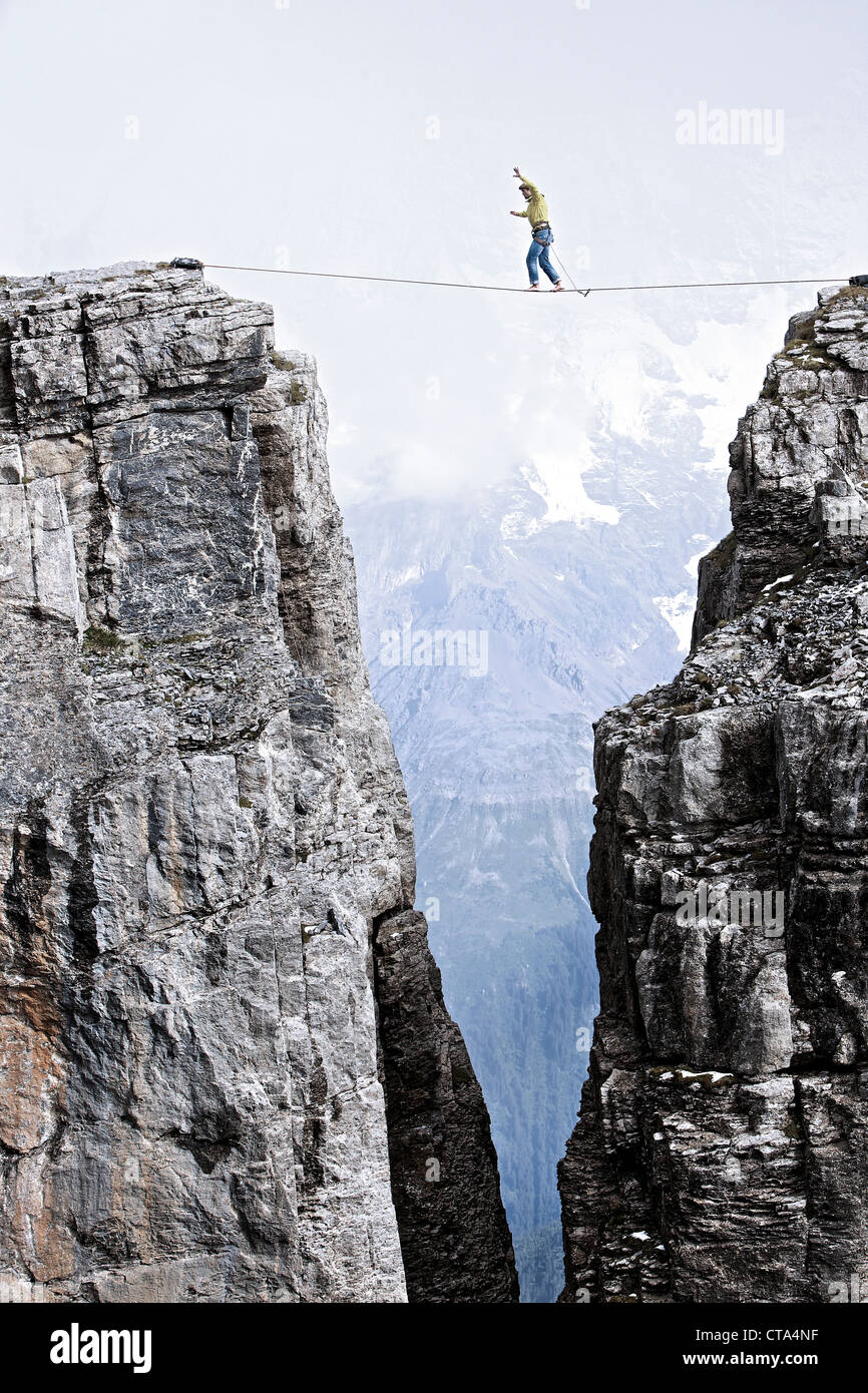 Man walking a highline between two rocks, Schilthorn, Bernese Oberland ...