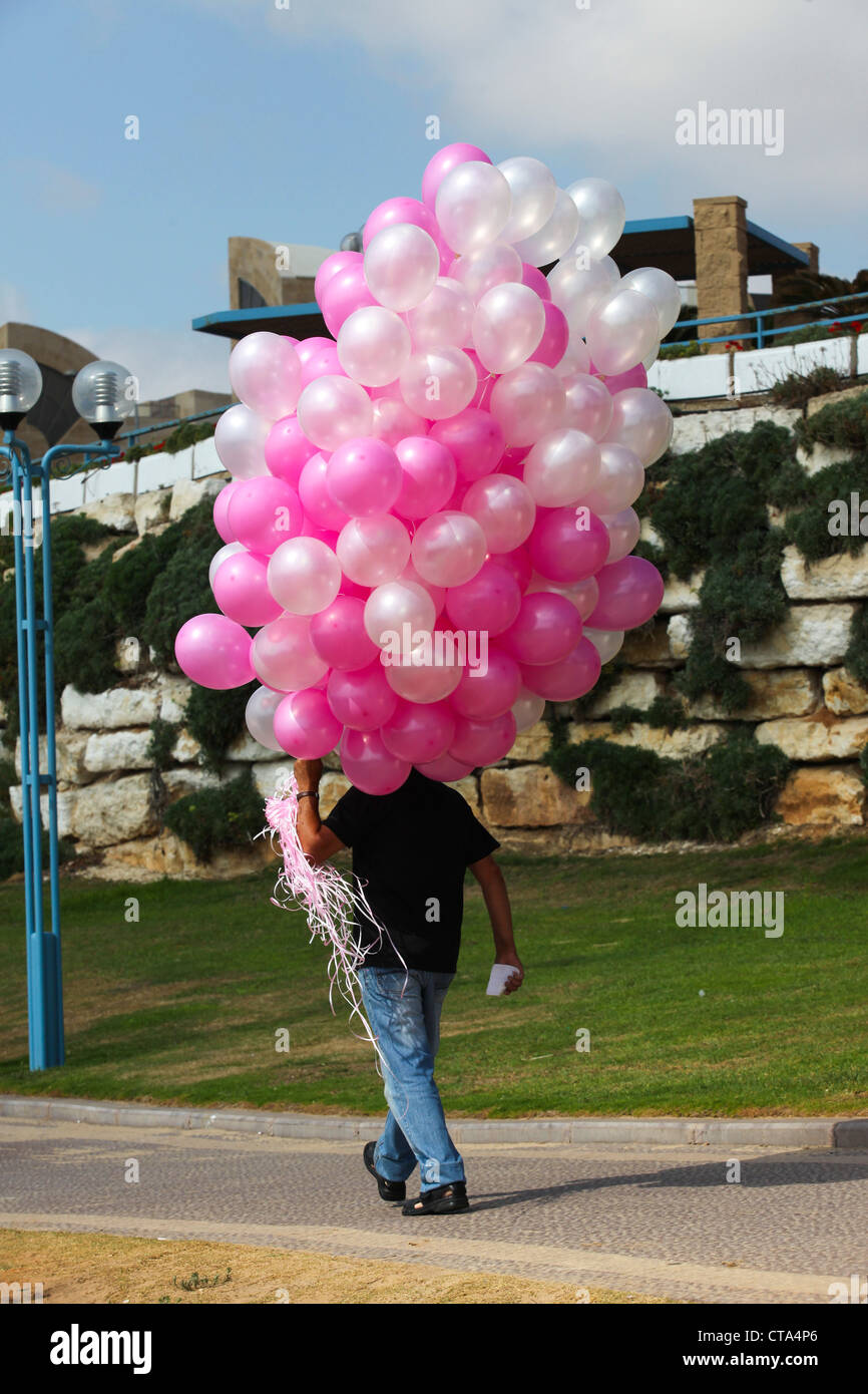 Man with pink and white balloons Stock Photo - Alamy
