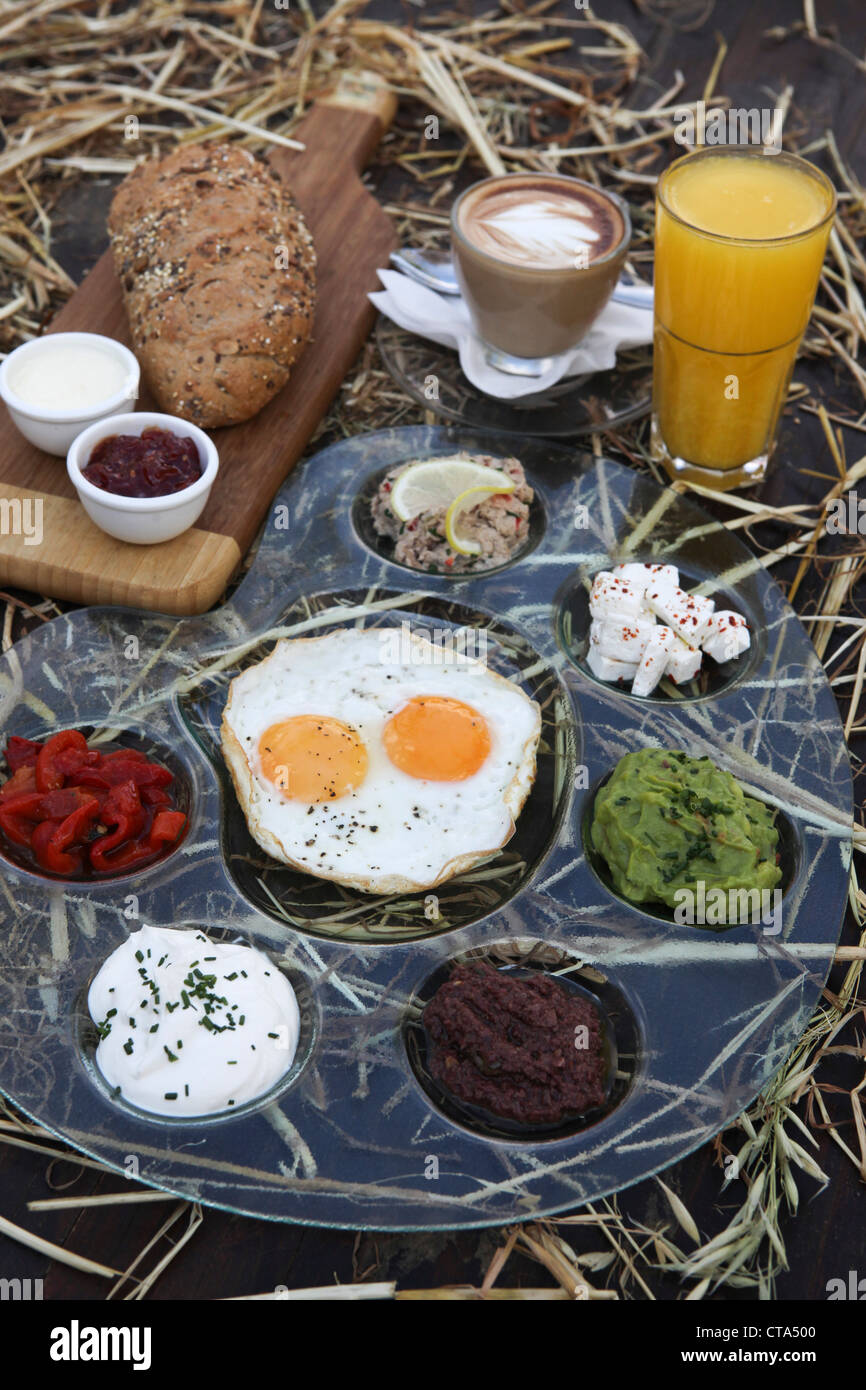 Traditional Israeli Breakfast with two fried eggs, cheeses, salads ...