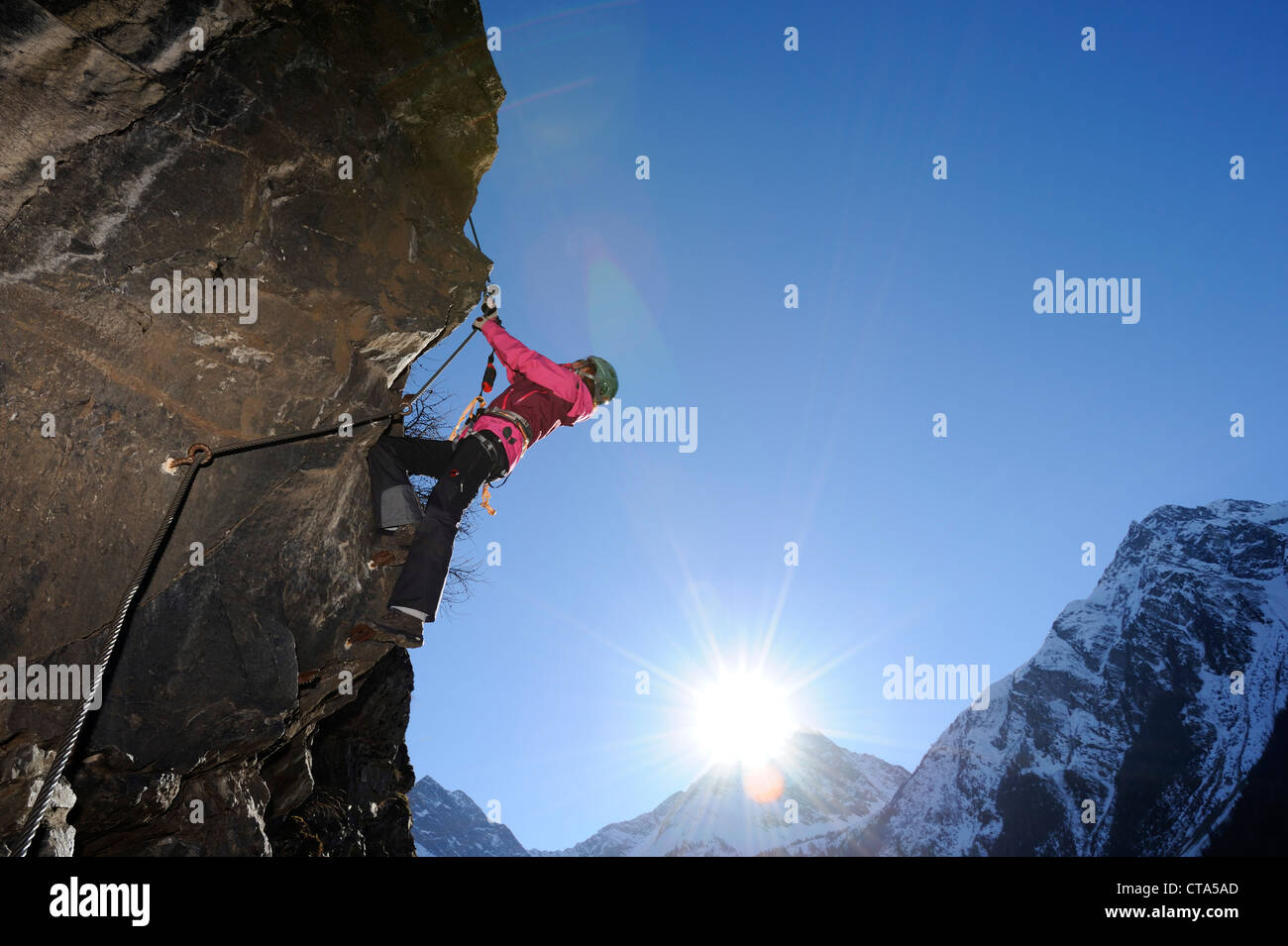 Woman climbing overhang in fixed rope route, Schiestl-via ferrata ...