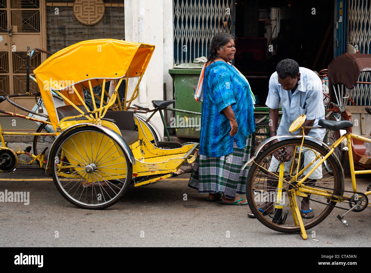 Traditional bicycle and riksja repairman in the backstreets of ...