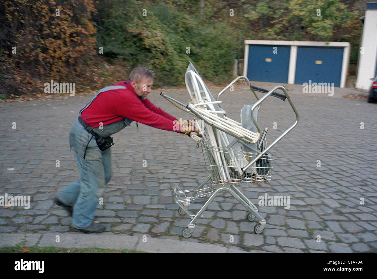 Worker pushes a cart in front of it, Berlin Stock Photo - Alamy
