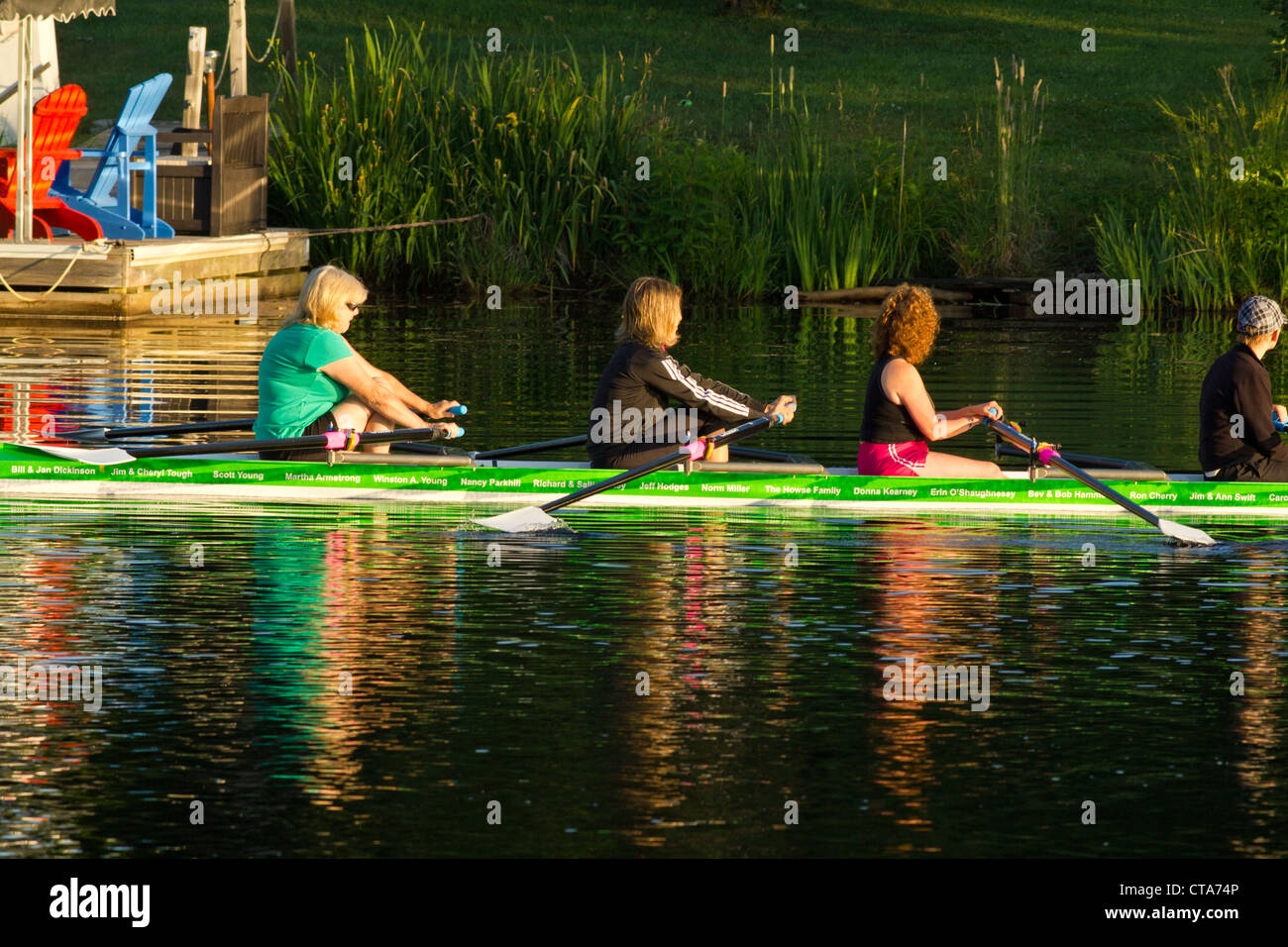 Women in a rowing boat Stock Photo - Alamy