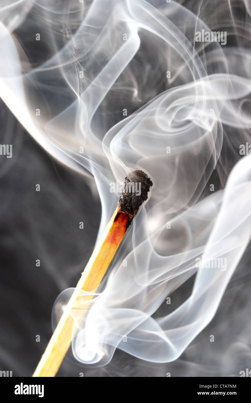 Photo of a burning match in a smoke on a black background Stock Photo ...