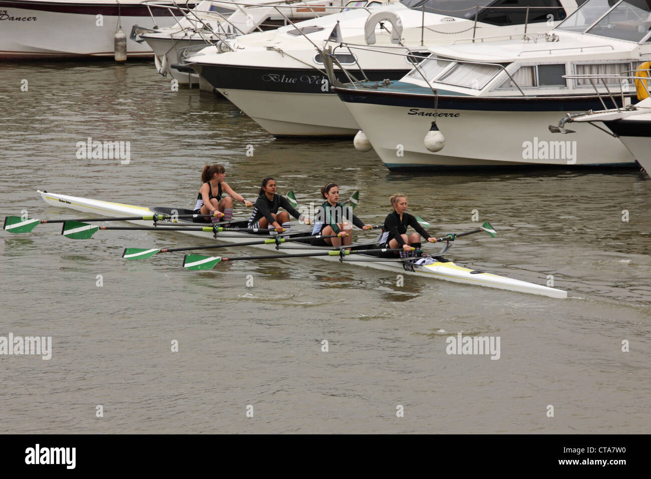 A young female coxless crew competing in a river race in Bristol UK ...