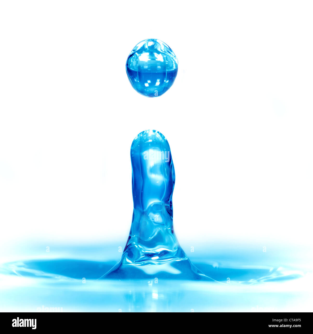 Falling drop of blue water Stock Photo - Alamy