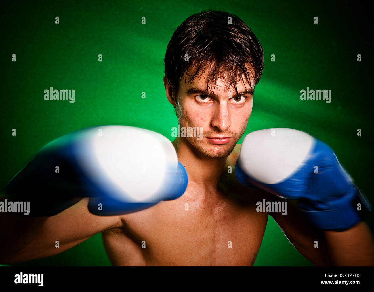 Man sweating all over in boxing gloves Stock Photo - Alamy