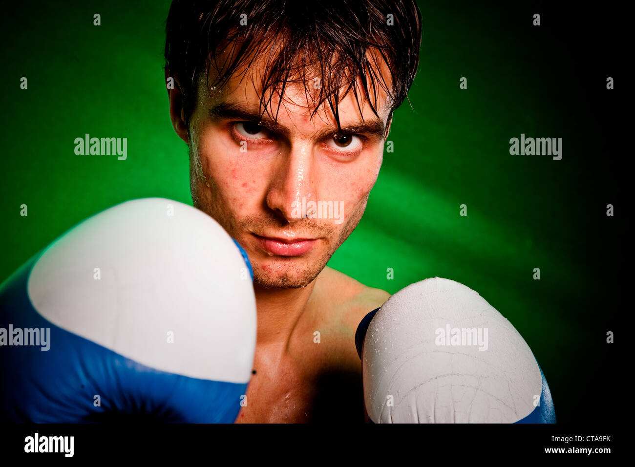 Man sweating all over in boxing gloves Stock Photo - Alamy