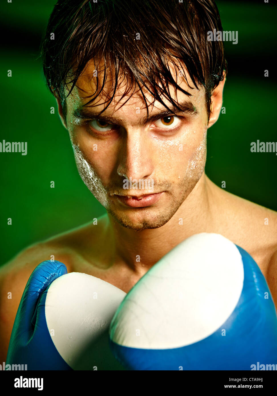 Man sweating all over in boxing gloves Stock Photo - Alamy