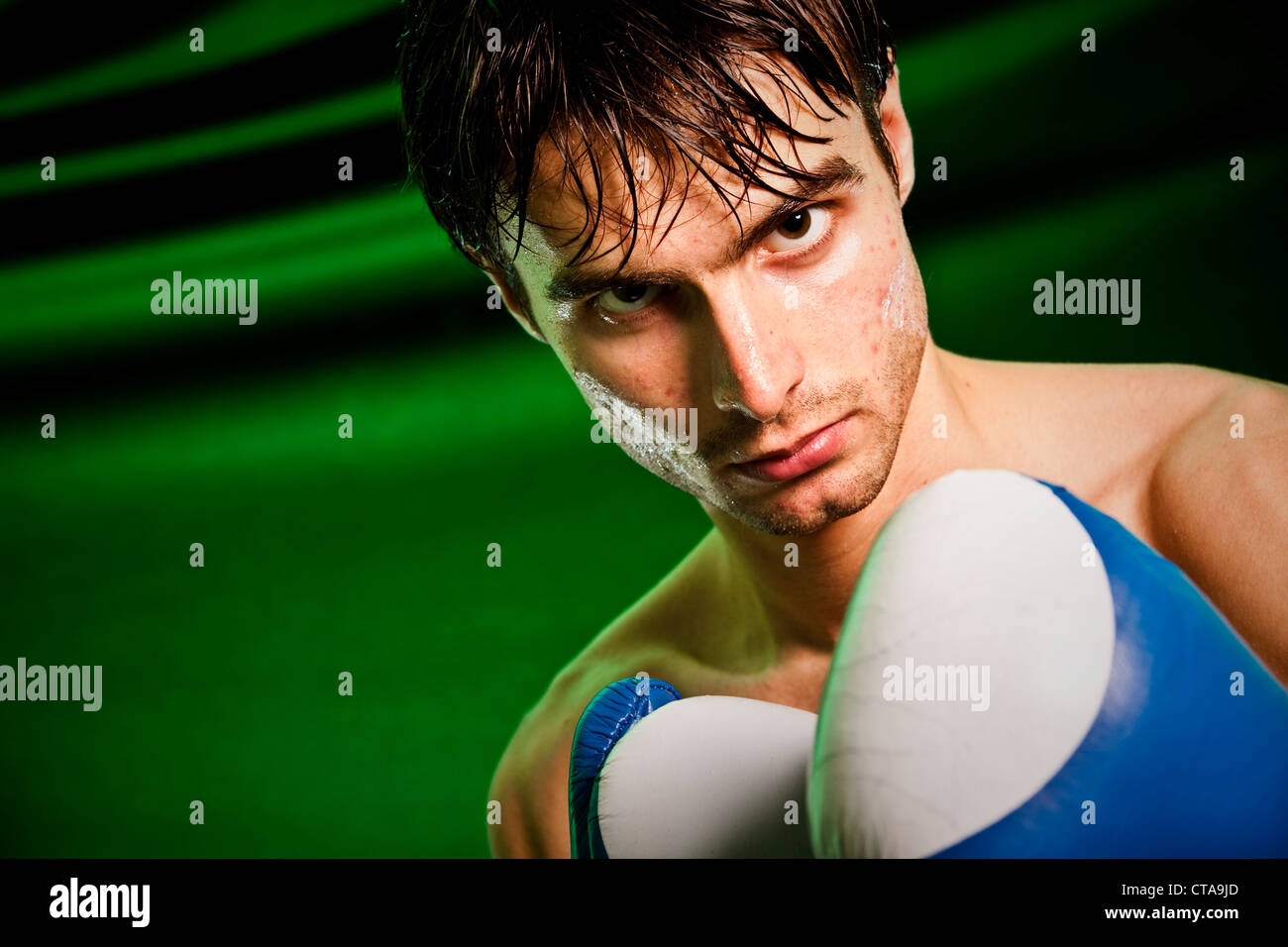 Man sweating all over in boxing gloves Stock Photo - Alamy
