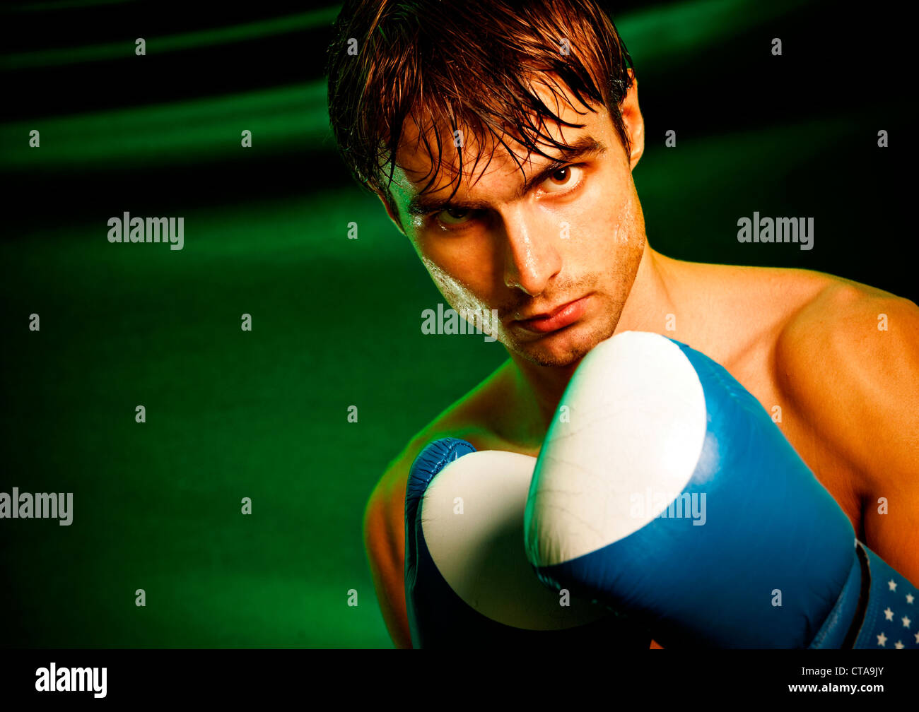 Man sweating all over in boxing gloves Stock Photo - Alamy