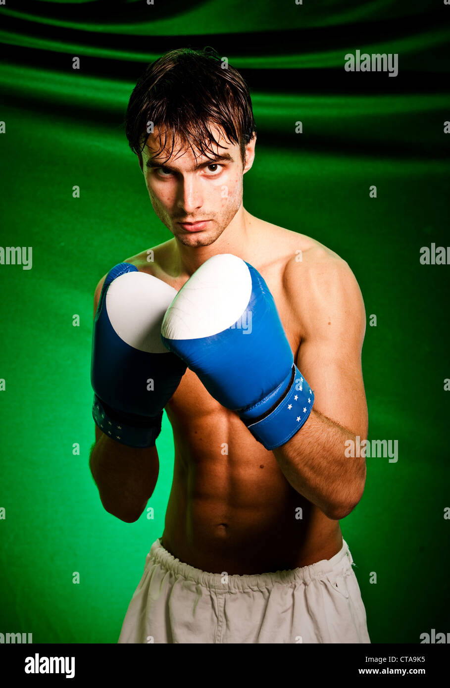 Man sweating all over in boxing gloves Stock Photo - Alamy