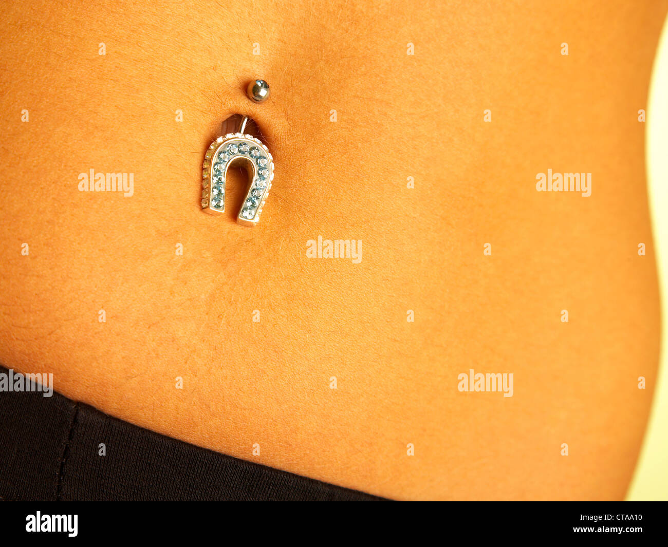 Female navel piercing hi-res stock photography and images - Alamy