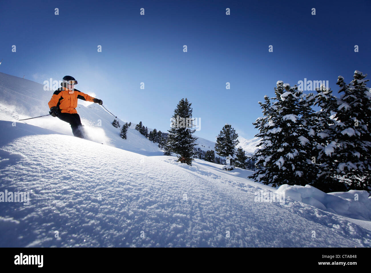 Skier sking down fresh new snow at Hohen Mut, Obergurgl, Tyrol, Austria ...