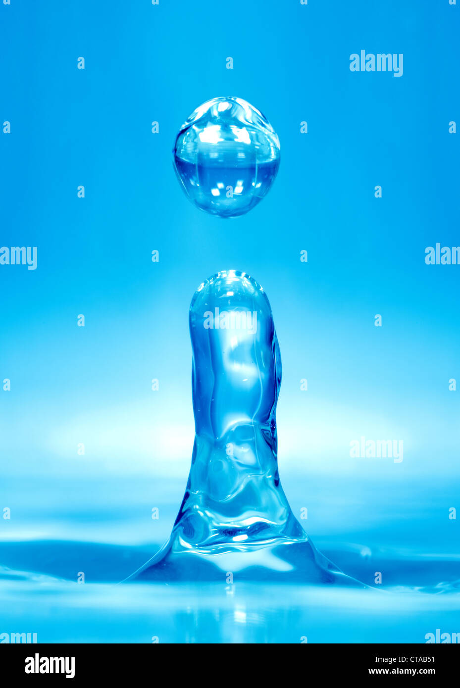 Falling drop of blue water Stock Photo - Alamy
