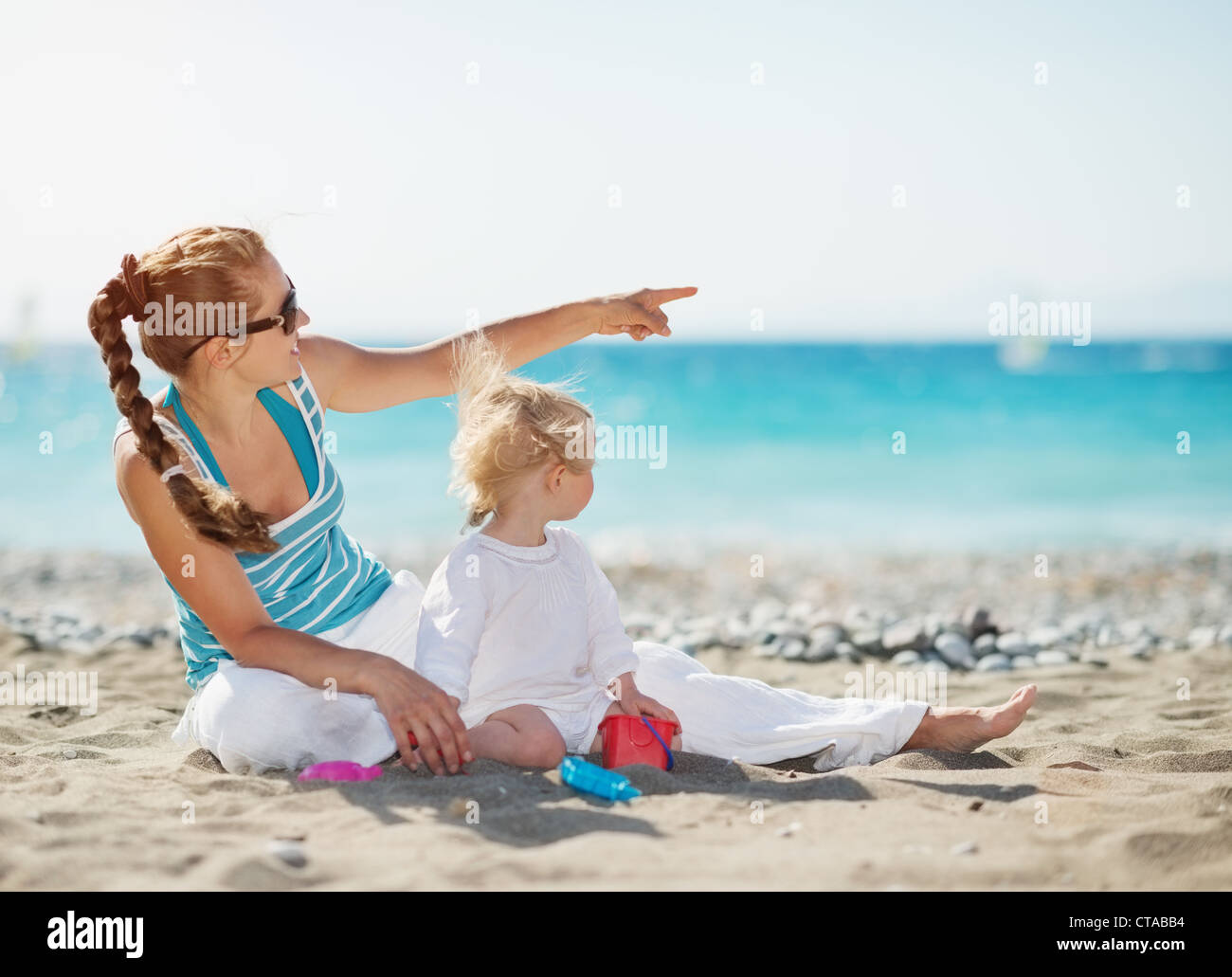 Mother pointing baby on copy space Stock Photo - Alamy