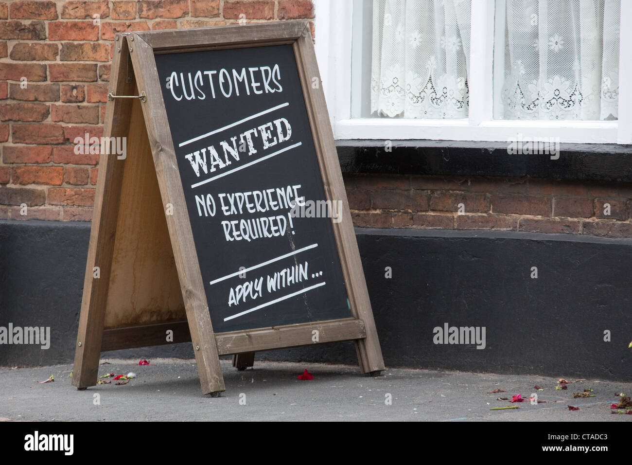 Customers wanted sign outside of a pub Stock Photo - Alamy