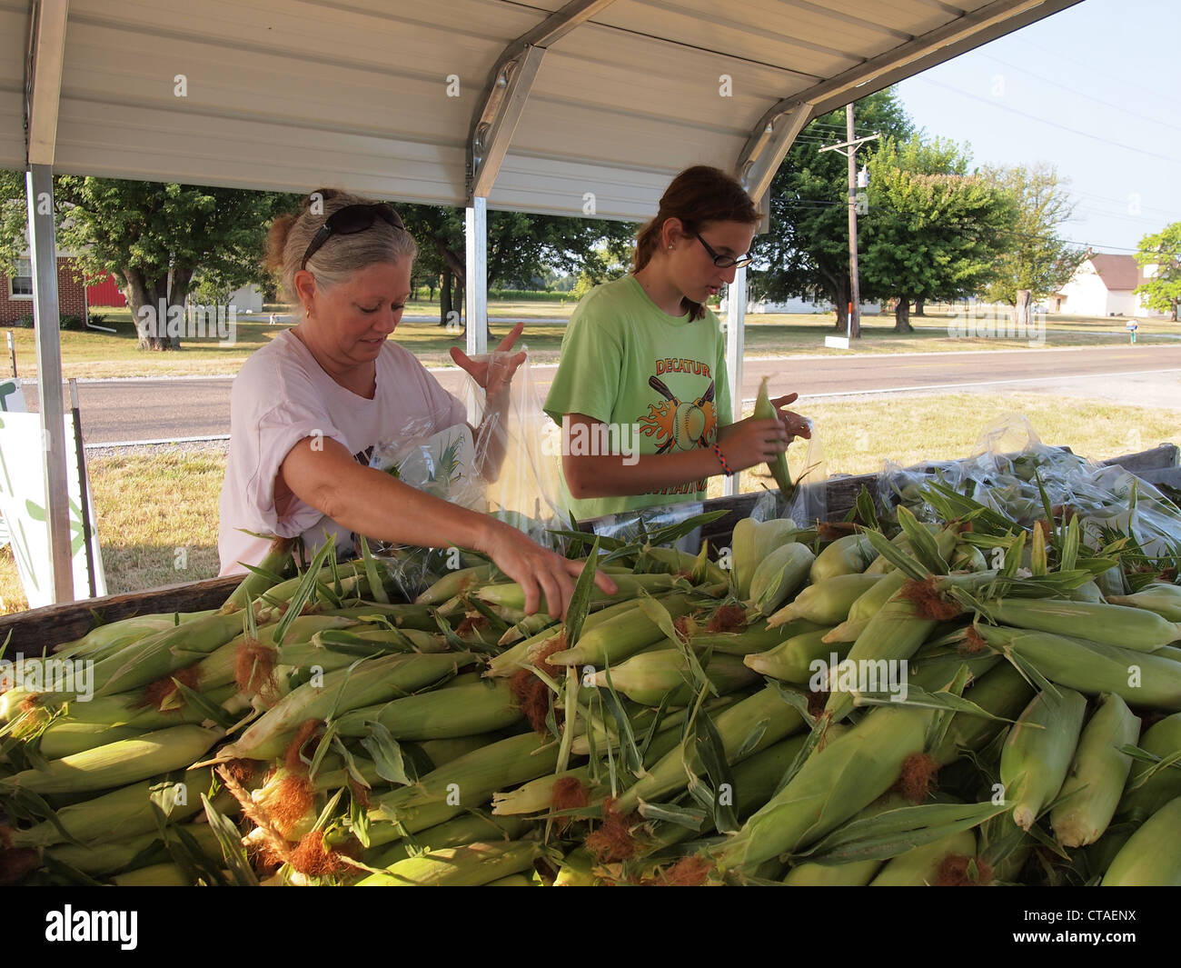 Girls selling corn hi-res stock photography and images - Alamy