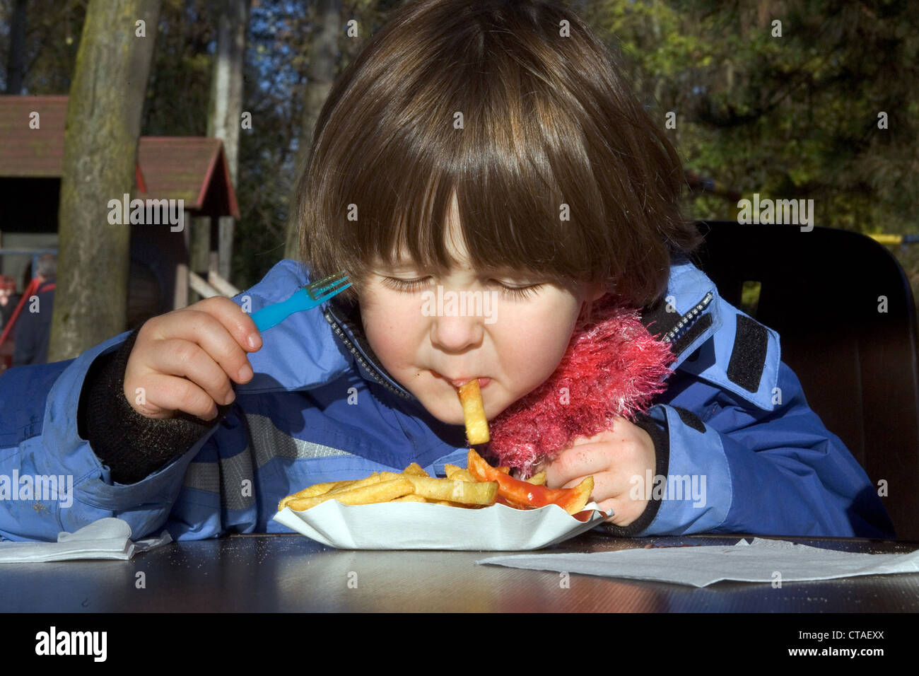 A child eats French fries Stock Photo - Alamy