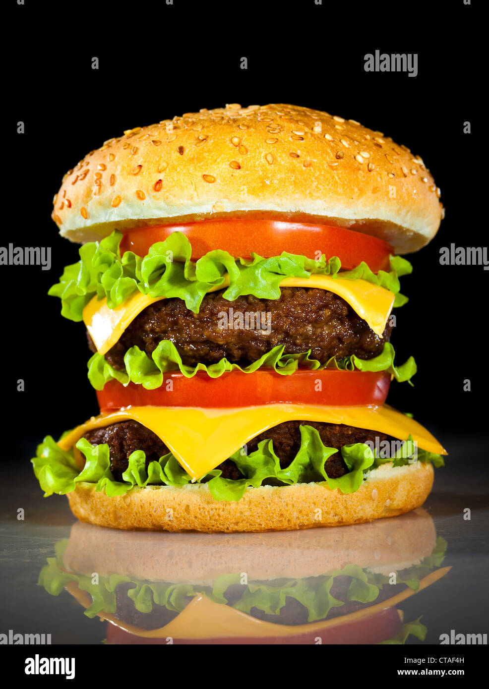 Tasty and appetizing hamburger on a dark background Stock Photo - Alamy