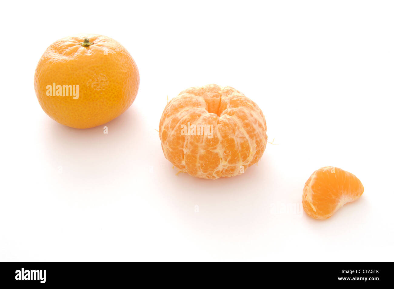 Mandarin oranges, whole, peeled and a segement isolated on a white ...