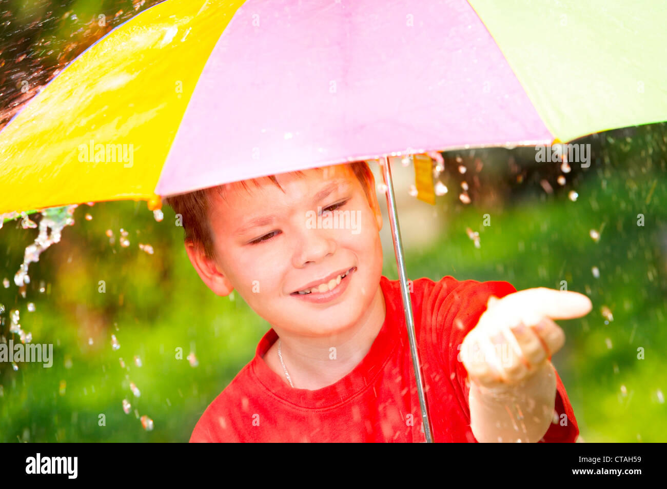 boy under an umbrella during a rain Stock Photo - Alamy