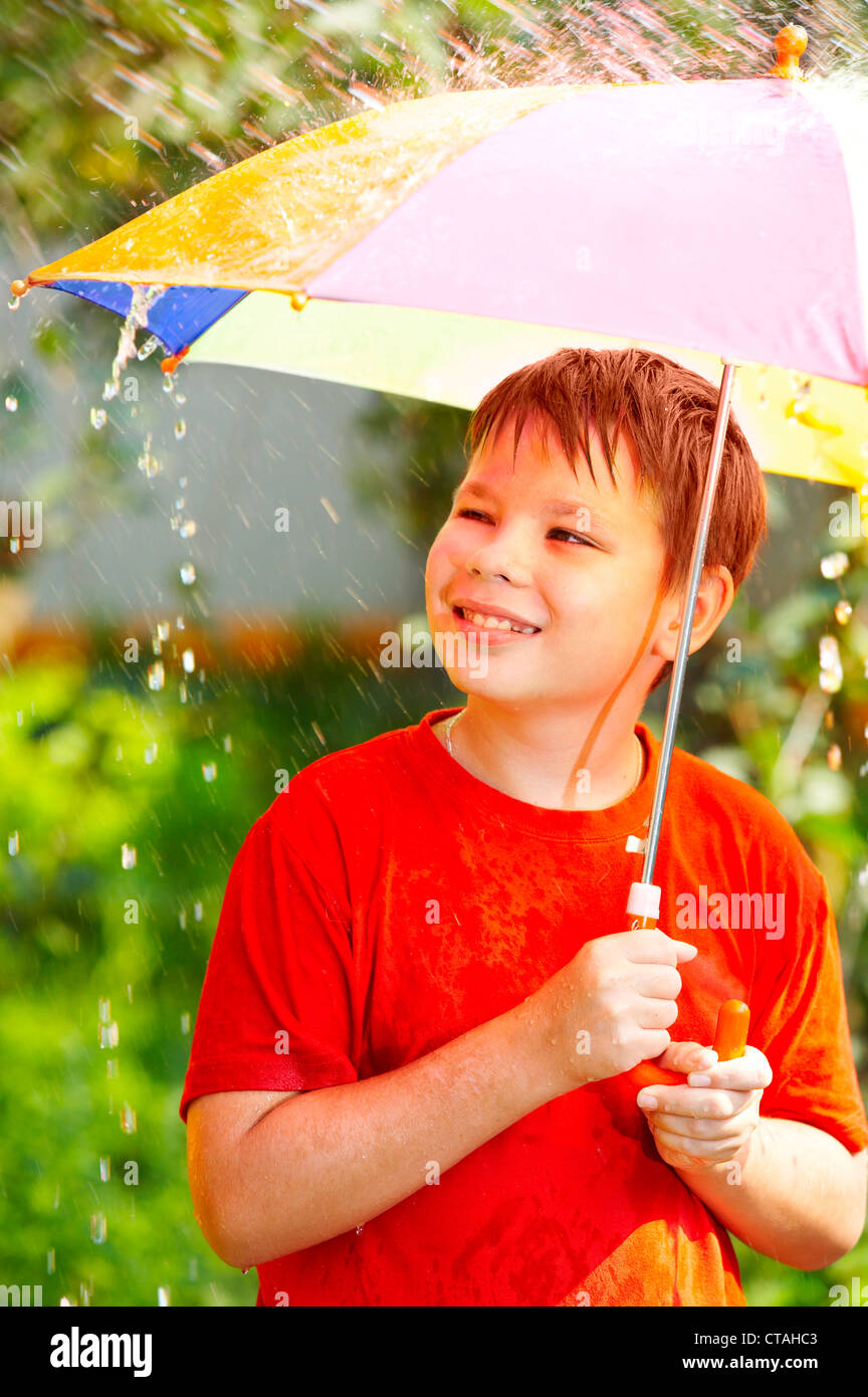 boy under an umbrella during a rain Stock Photo - Alamy