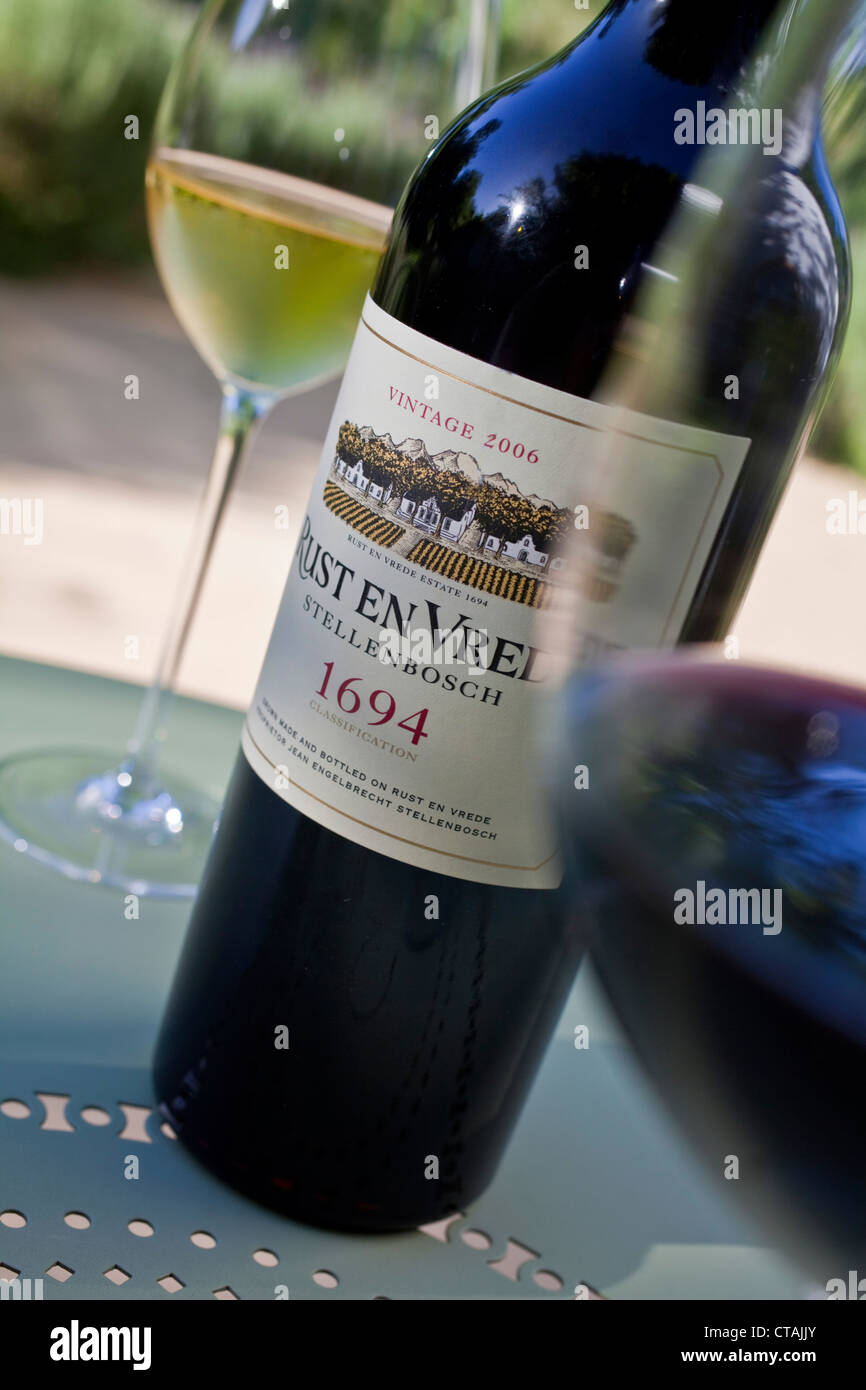 Glass of white and red wine with bottle at Rust en Vrede winery ...