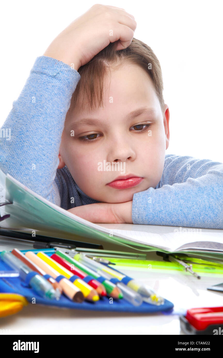 The boy behind a table with books Stock Photo - Alamy