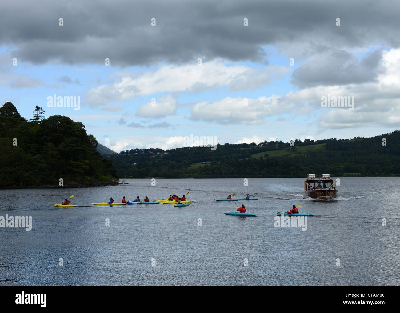 Canoes and passenger ferry on Derwent Water, Lake District, UK Stock ...