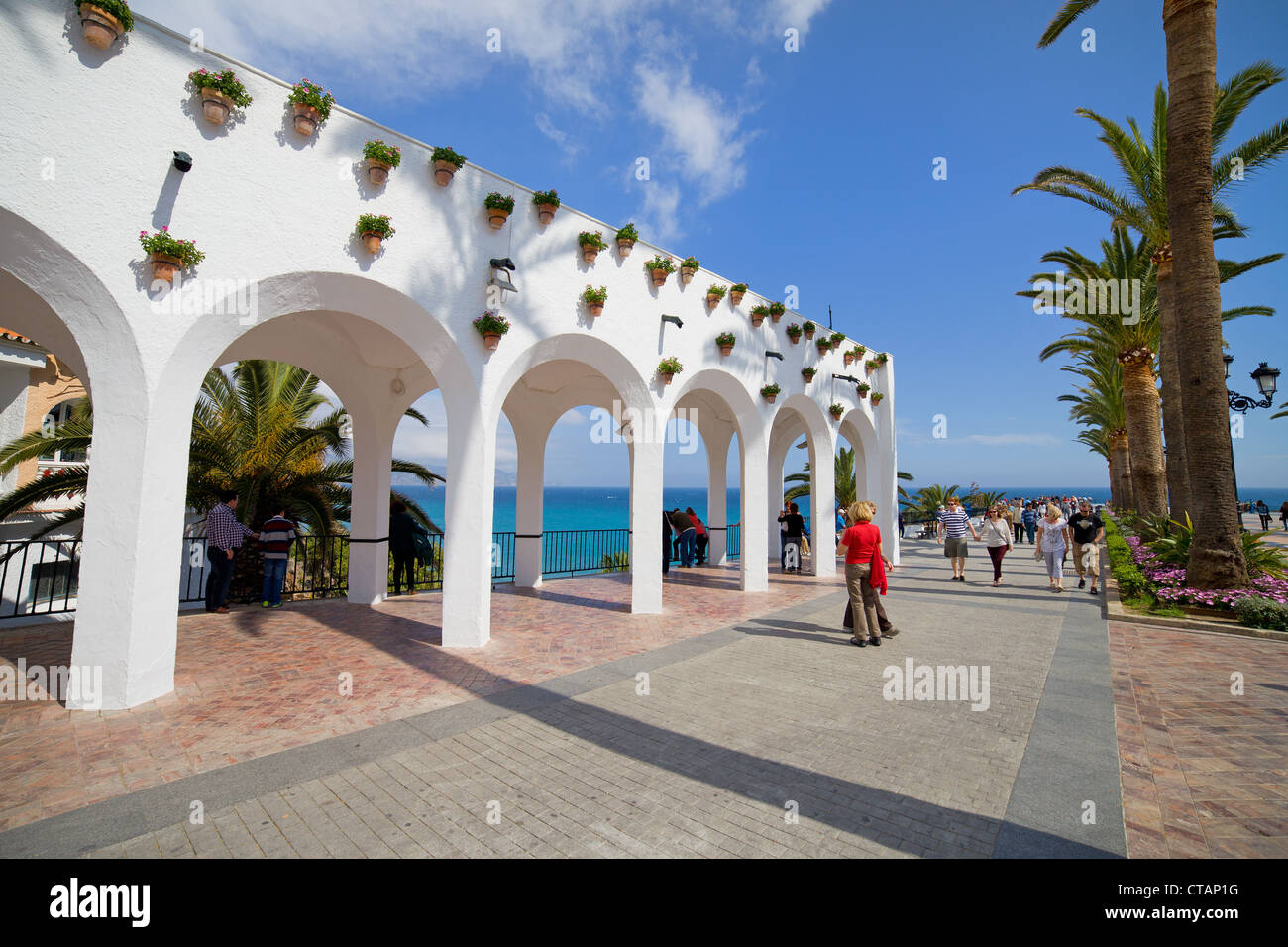 People on the Balcon de Europa promenade in resort town of Nerja on ...