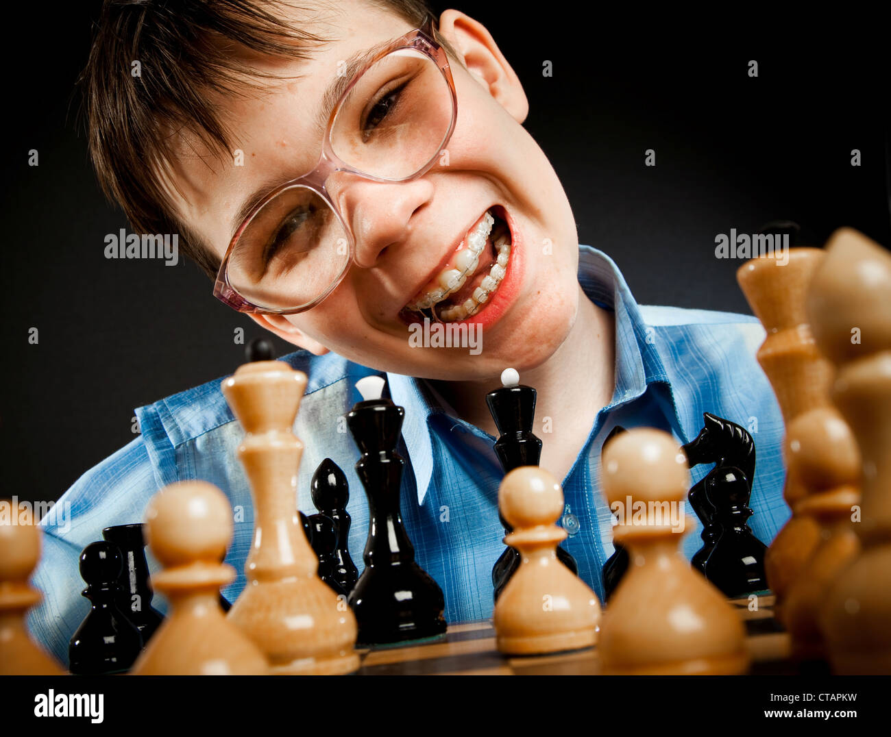 Nerd play chess on a black background Stock Photo - Alamy