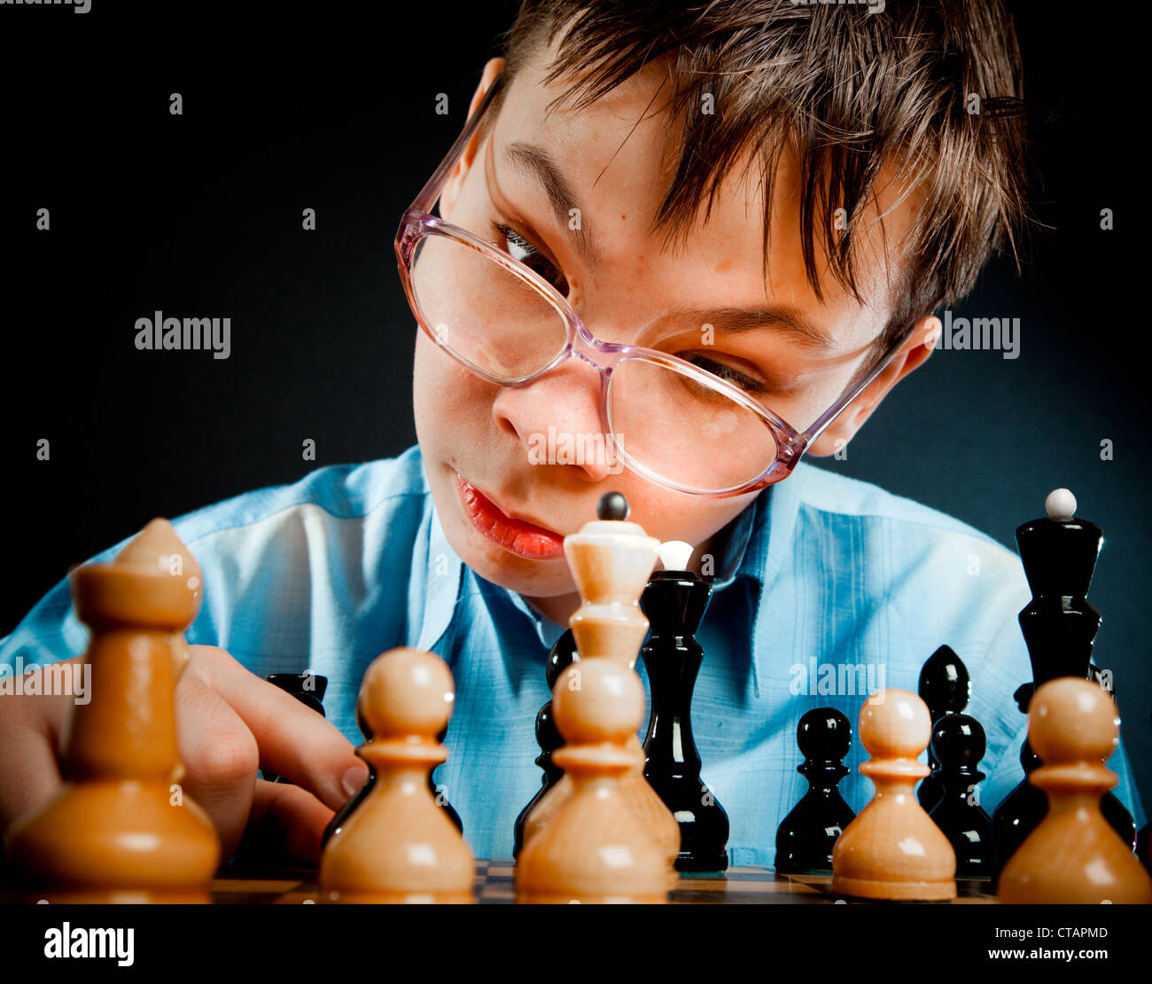 Nerd play chess on a black background Stock Photo - Alamy