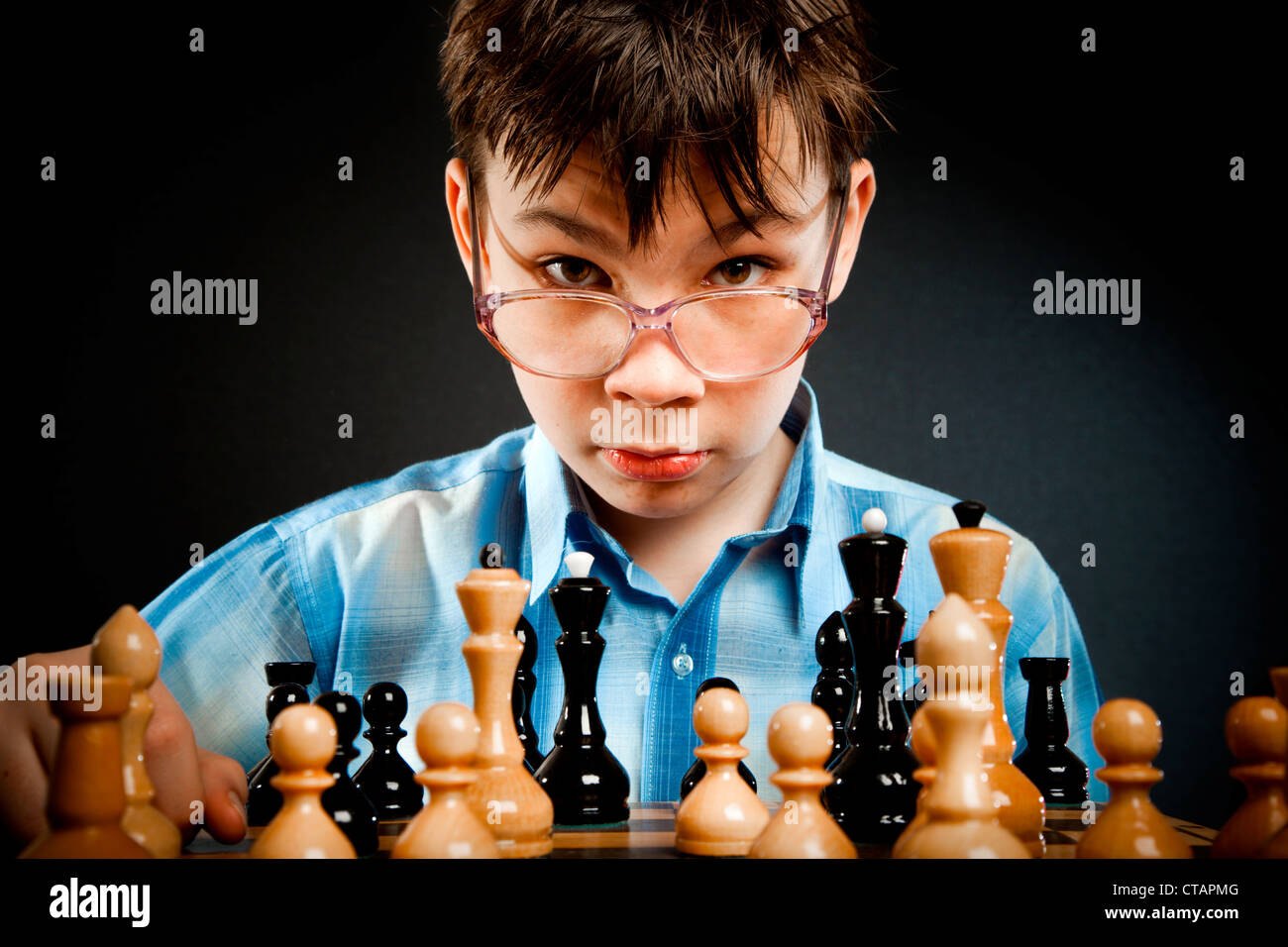 Nerd play chess on a black background Stock Photo - Alamy